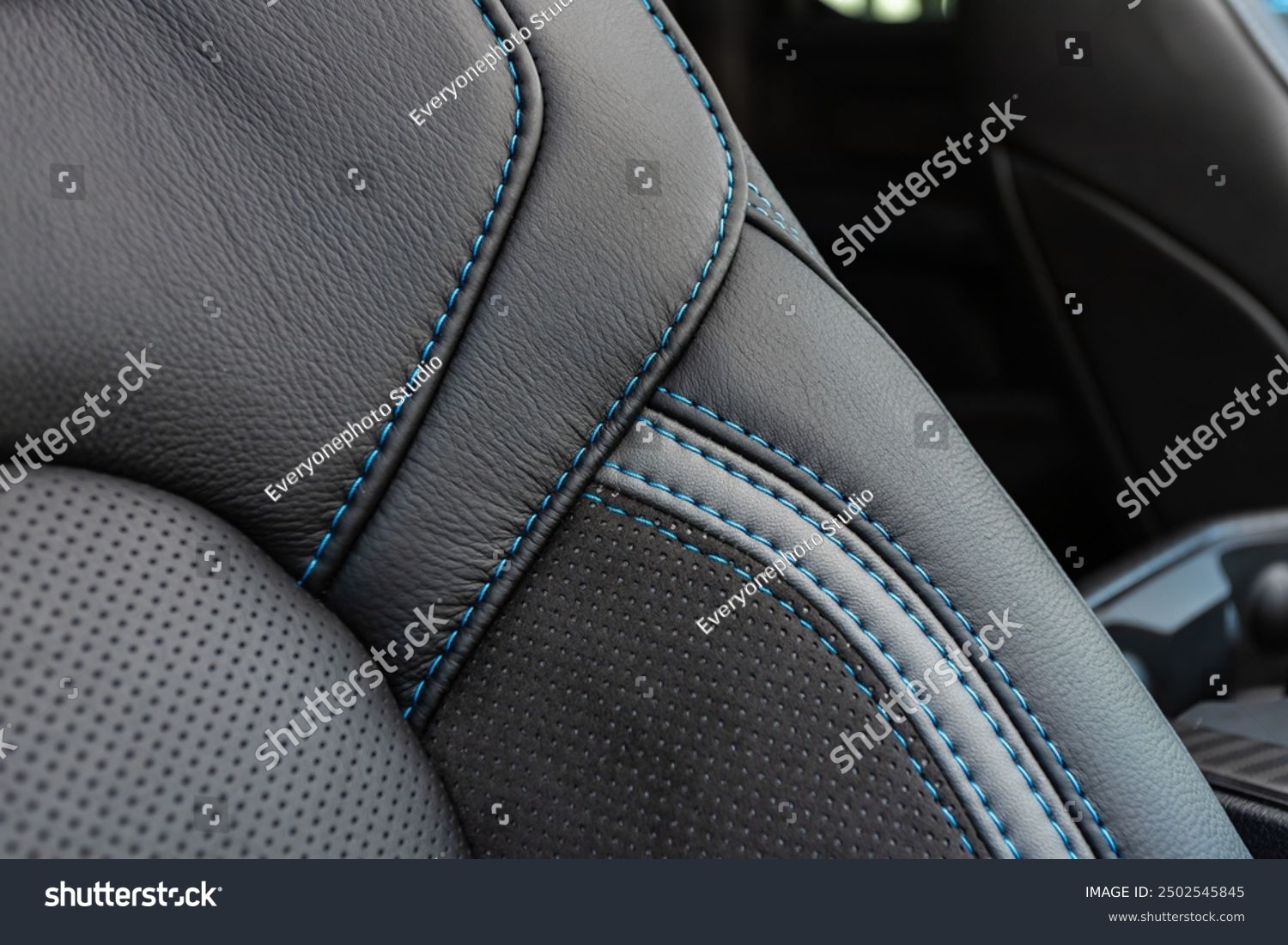 Part of leather car headrest seat details. Сlose-up black and blue ...