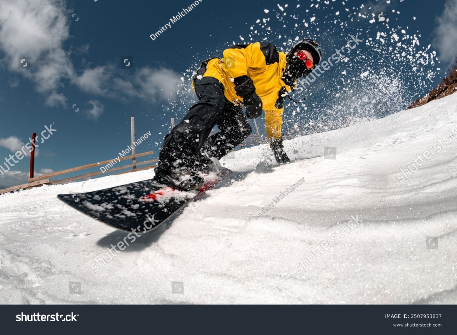 Extreme close up photo of snowboarder is riding at ski slope against ...