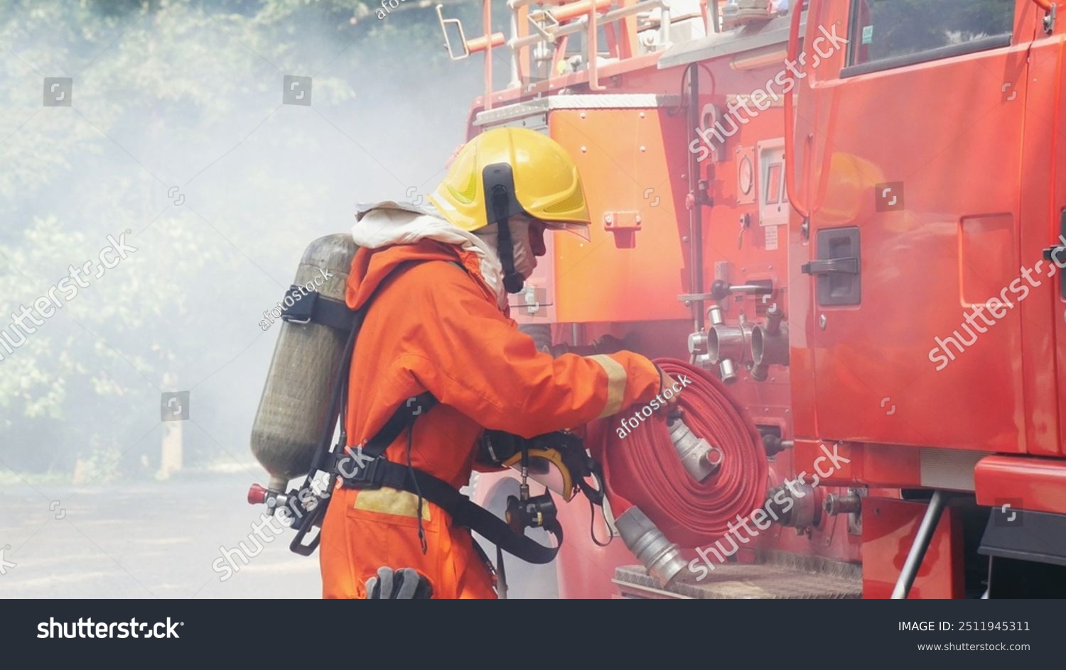 Fireman prepare equipment at fire engine truck. Man hand connect water ...