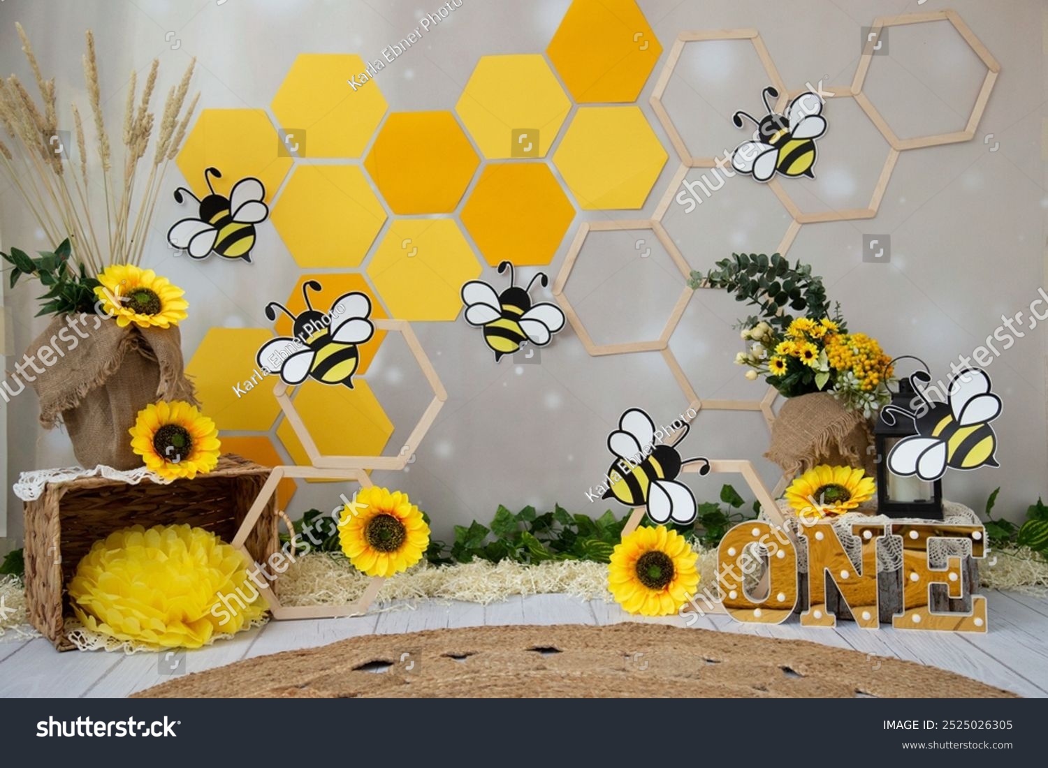 A bee-themed decoration setup likely for a first birthday celebration ...
