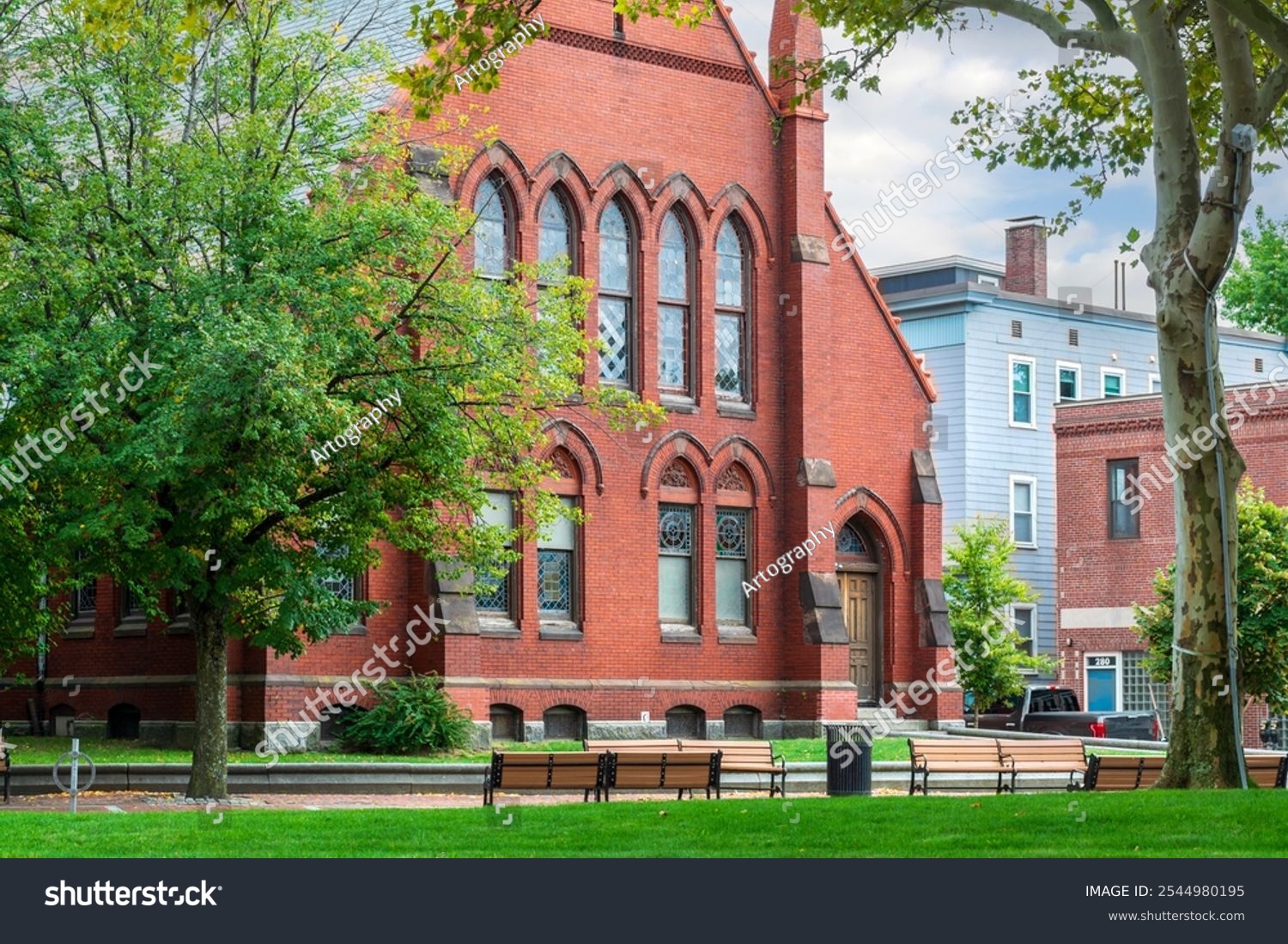 Gothic-style red-brick Central Square Church with arched windows on an ...