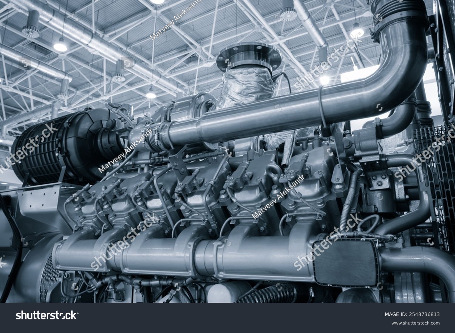 Big gas engine diesel generator electric power with many wires pipes ...