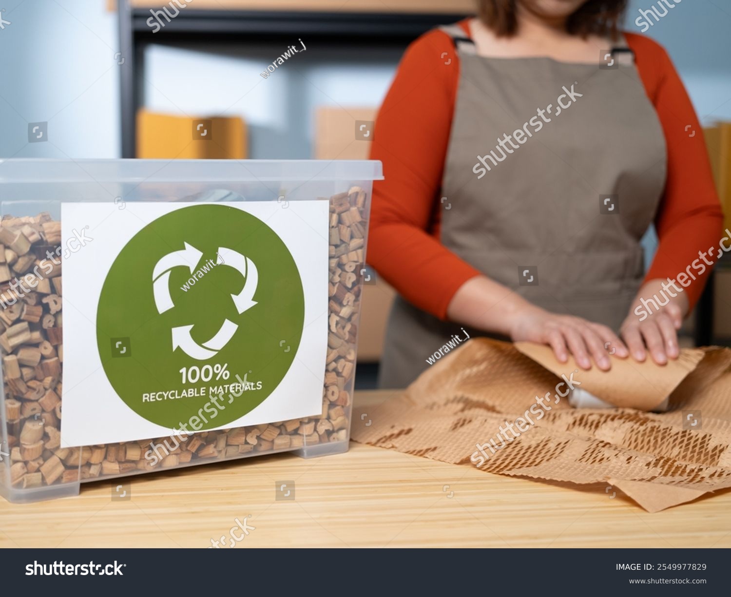 The focus is on a label stating "100% Recyclable Materials ...