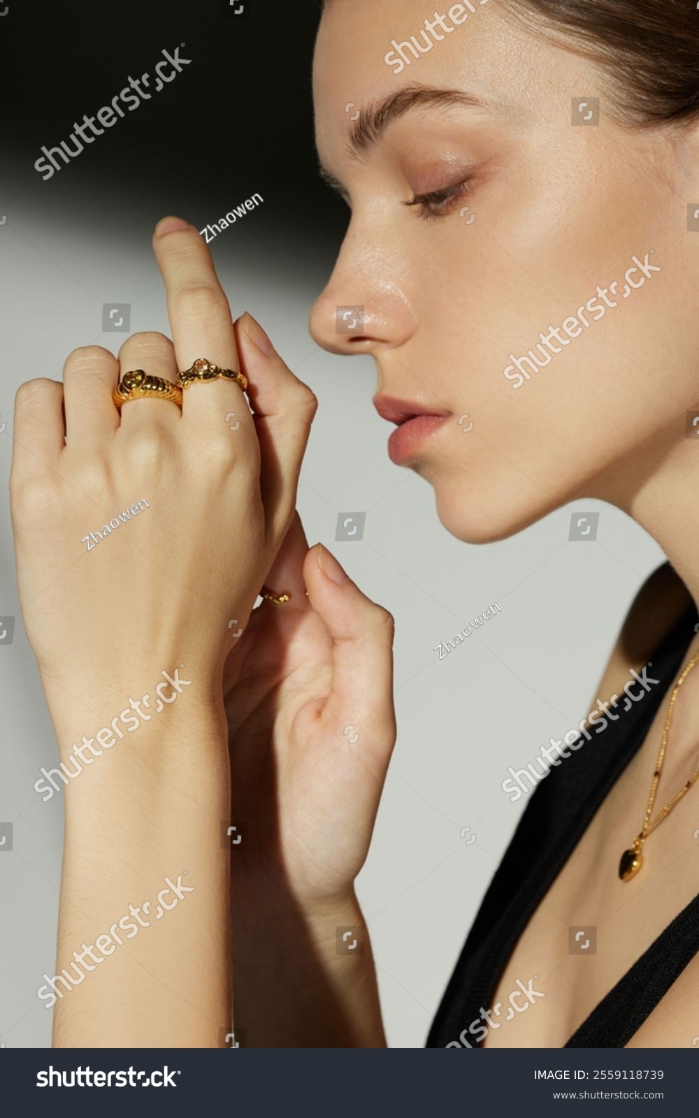 Elegant Woman Showcasing Gold Jewelry – Close-Up of Stylish Rings and Necklace on Minimalist ...