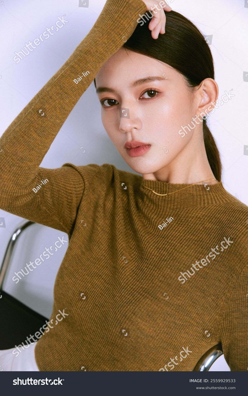 Stylish Portrait of a Confident Woman in a Mustard Brown Sweater Showcasing Minimalist Fashion ...