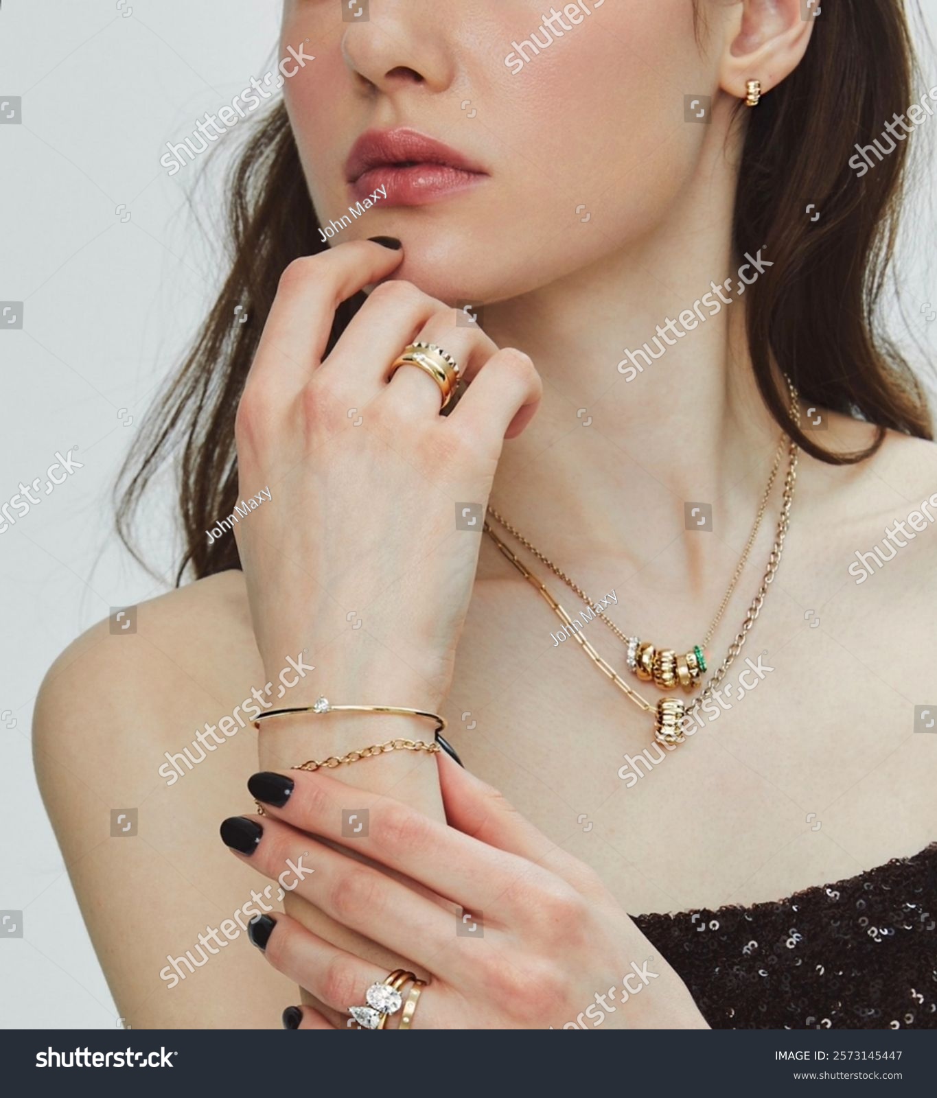 Portrait of a beautiful woman in her thirties with makeup and smooth skin with a gold necklace ...