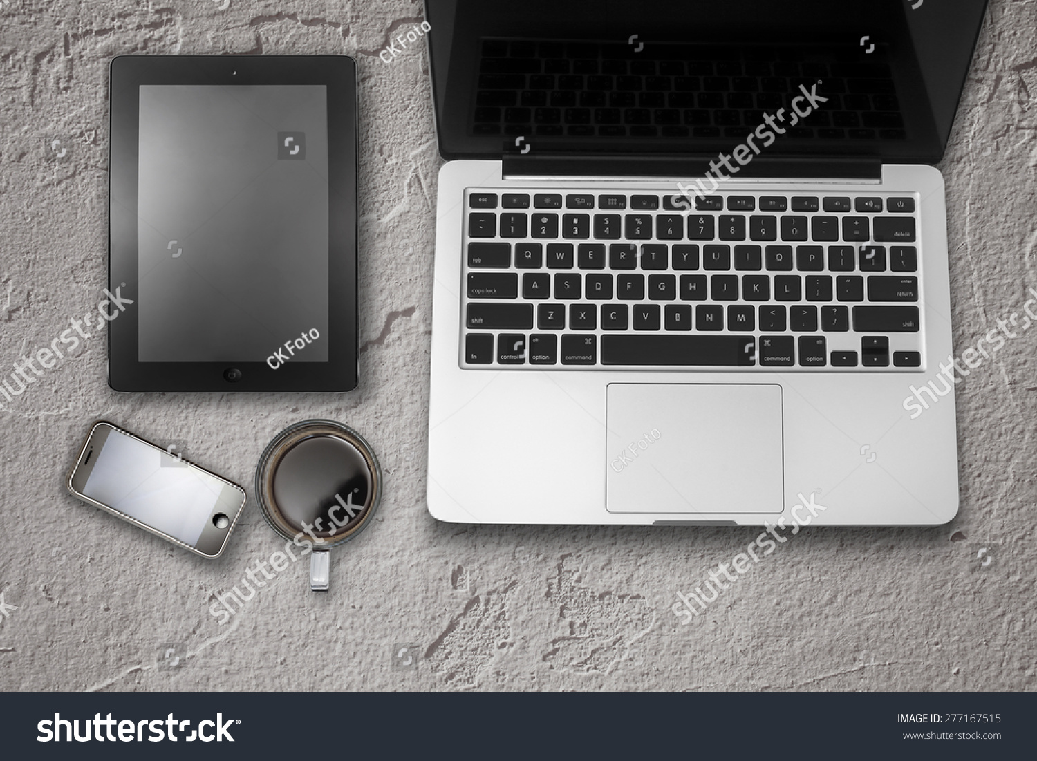 Laptop tablet computer with and cup of coffee on stone Simple workspace ...