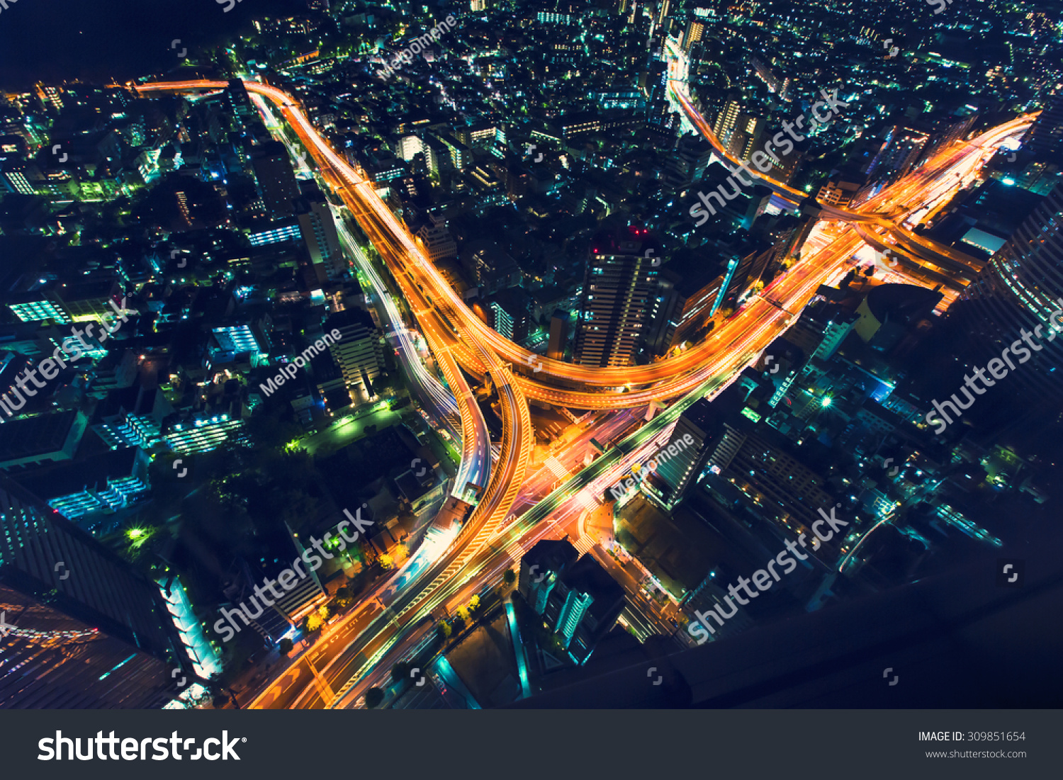 A massive highway intersection from above at night in Shinjuku Tokyo ...