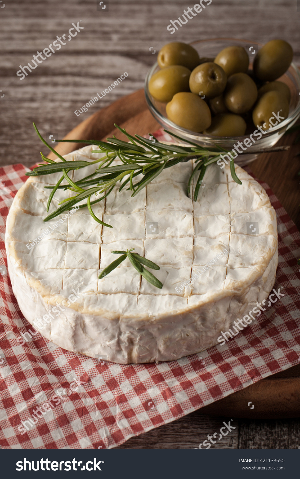 Brie type of cheese. Camembert cheese. Fresh Brie cheese and a slice on ...