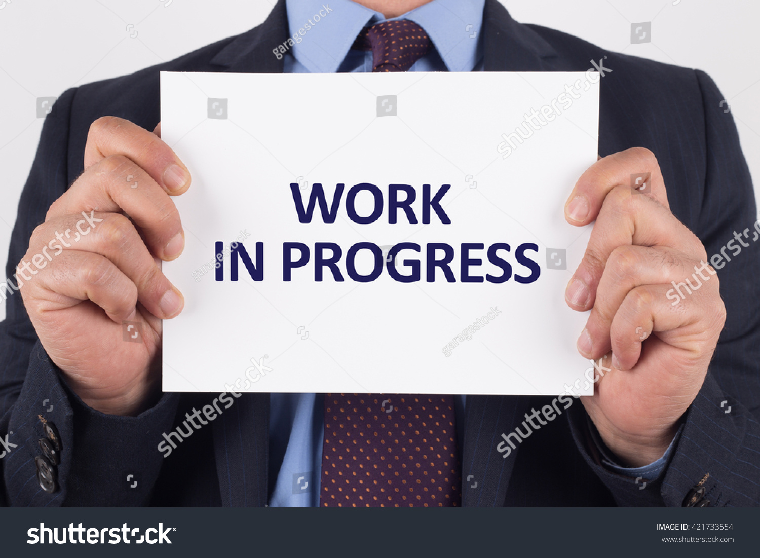 Man showing paper with WORK IN PROGRESS text_站酷海洛_正版图片_视频_字体_音乐素材交易平台_站 ...