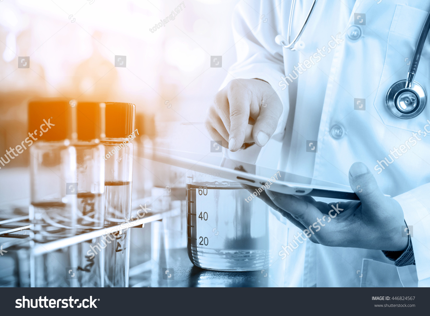Doctor using tablet with teat tube in rack medical research and ...