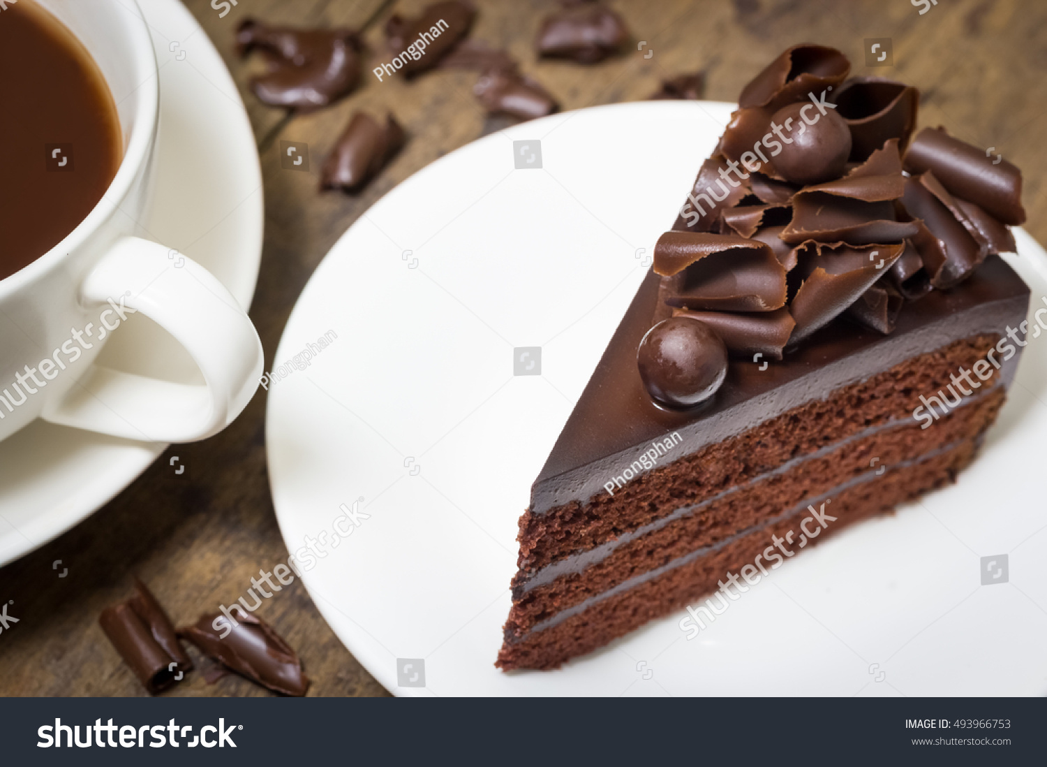 Closeup triangle slice piece of delicious dark chocolate fudge cake on ...