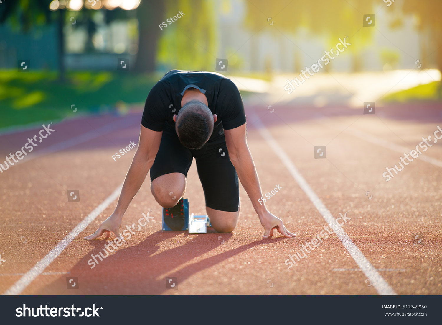 Athletic man on track starting to run. Healthy fitness concept with ...