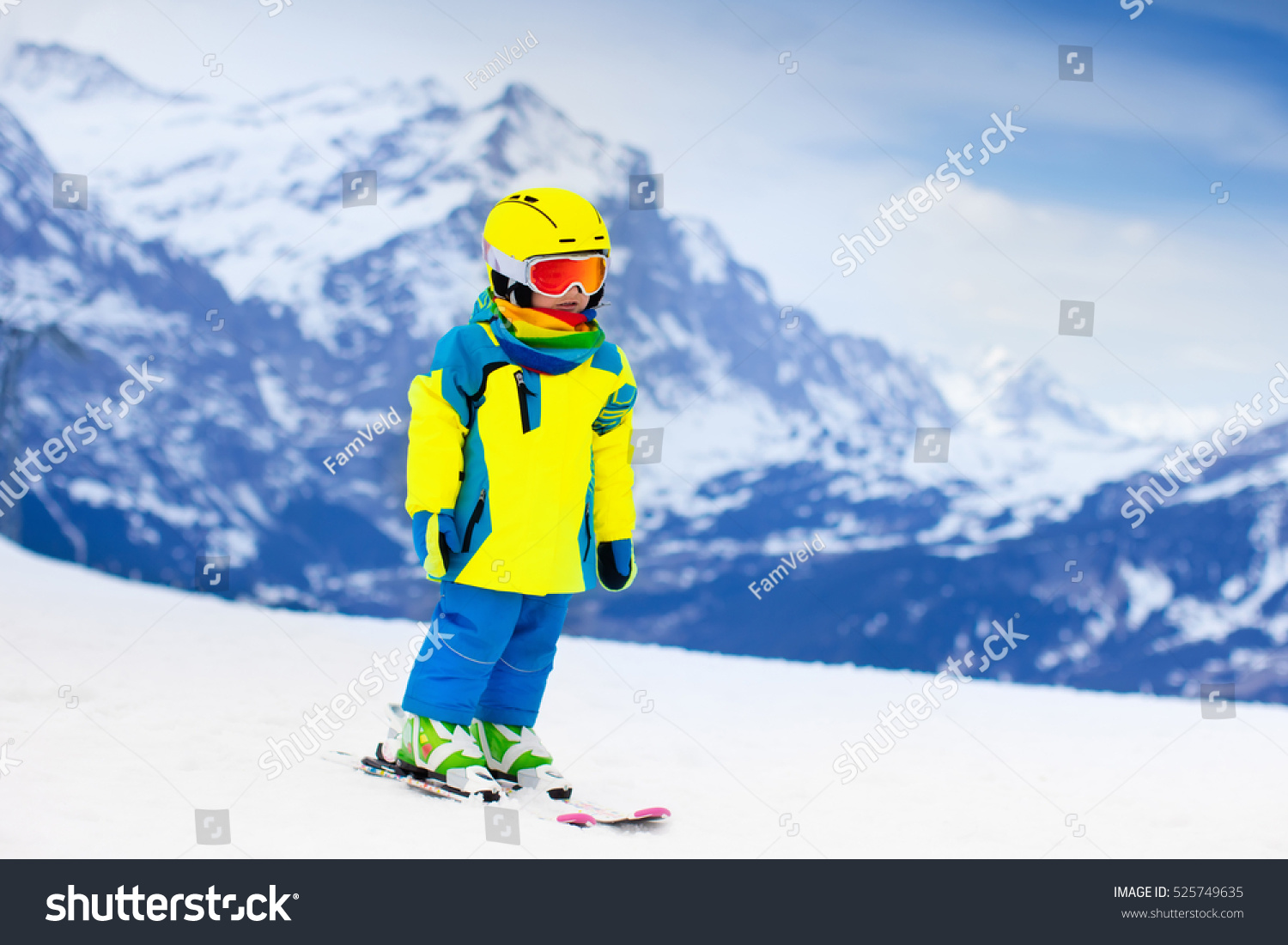 Child skiing in mountains. Active toddler kid with safety helmet ...