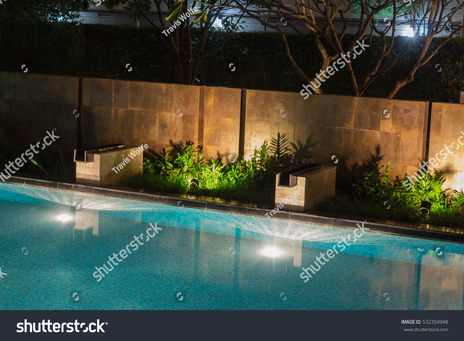 Peaceful pool reflections amid mood lighting and lush greenery giving ...
