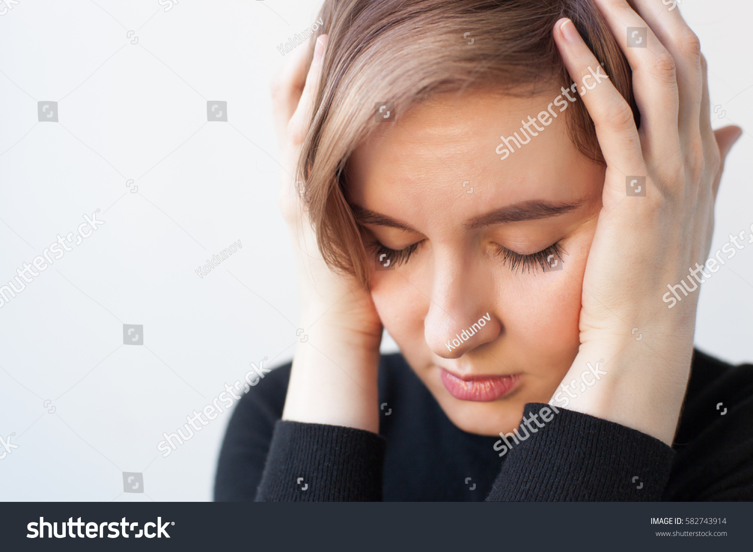 girl in grief and sadness covers his ears and eyes fenced off from the ...