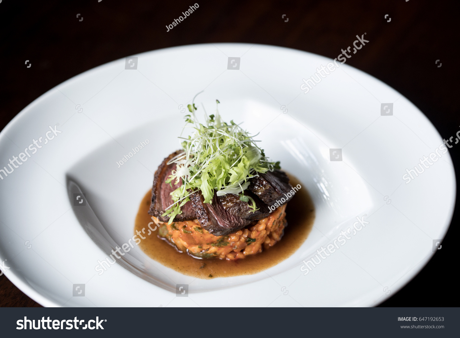 A Pumpkin Risotto with duck on a plate Served on a white plate with ...