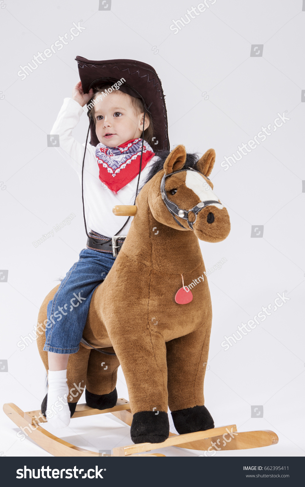 Little Children Concepts. Little Caucasian Girl in Cowgirl Clothing Posing On Symbolic Horse ...