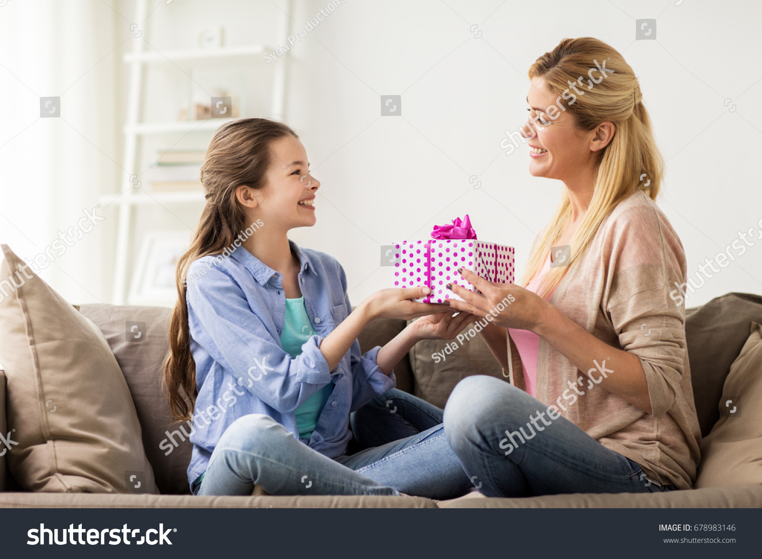 people holidays and family concept - happy girl giving birthday present ...