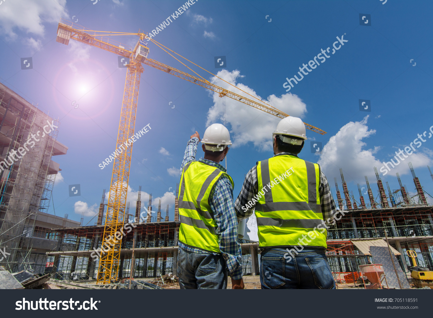 Civil engineer checking work with walkie-talkie for communication to ...