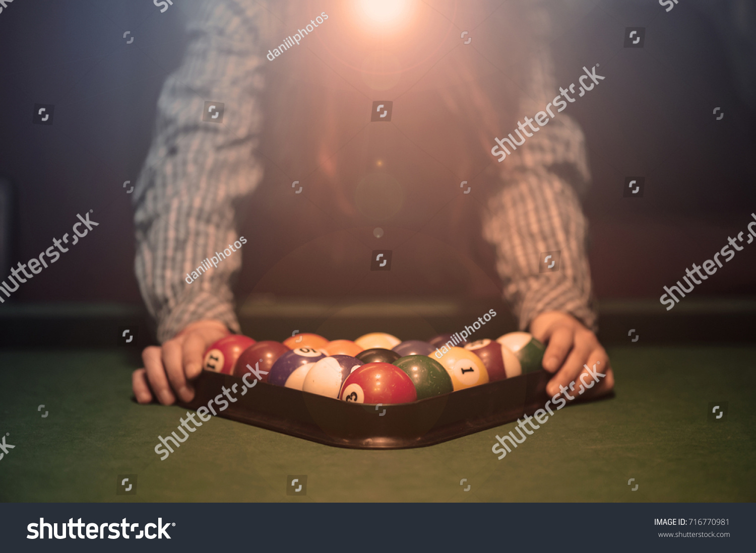 American billiard poule. Triangle of billiard balls. A man getting ...