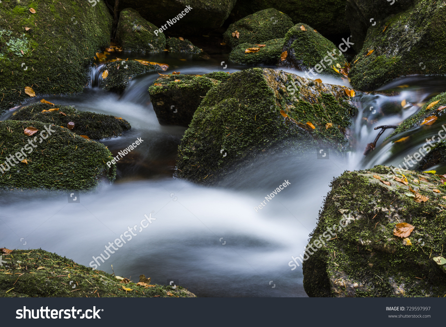 Waterfall falling on stones through autumn forest. Fall nature ...