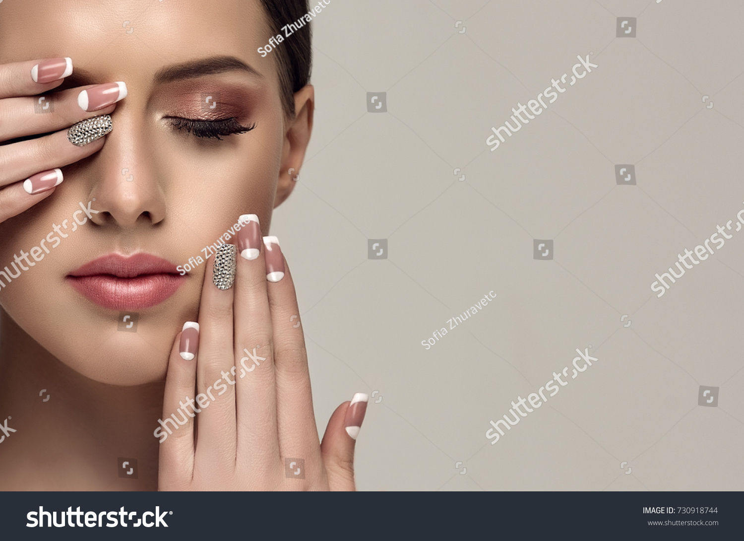 Beautiful model girl with a beige French manicure nail design with ...