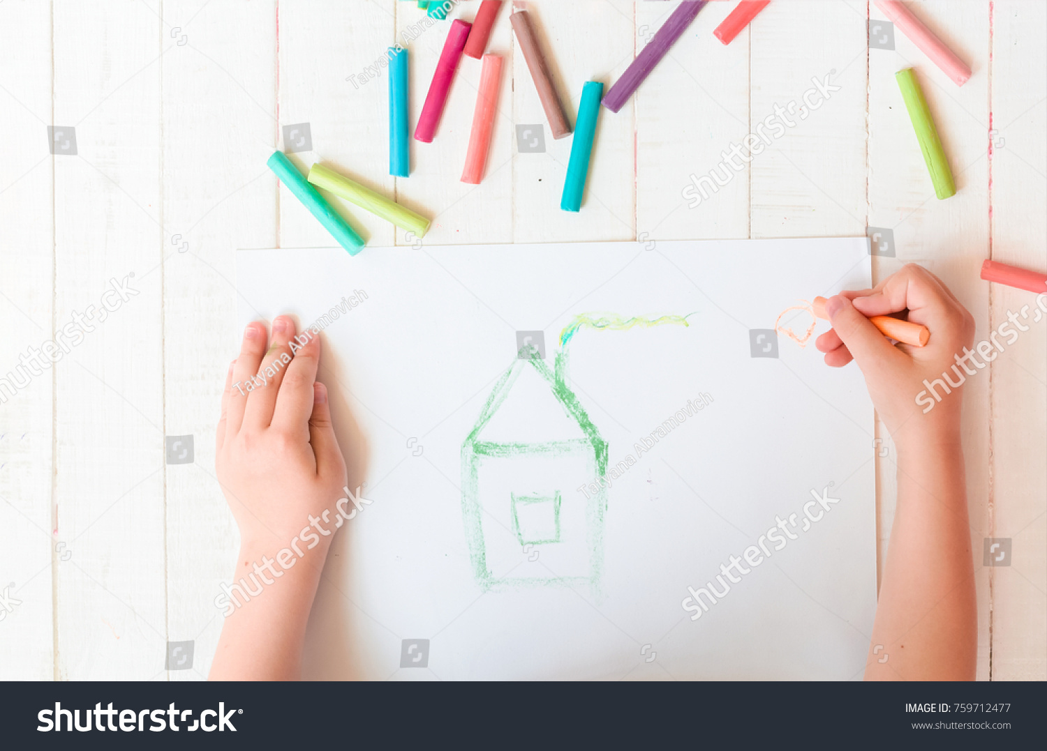 A child draws a house with crayons. House. Multicolored crayons pastel ...